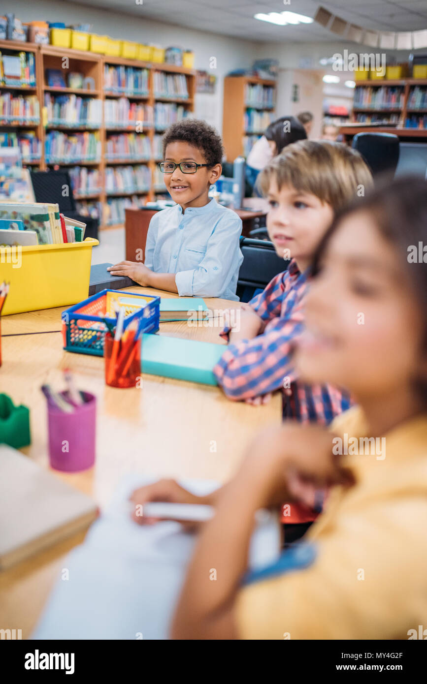 adorable little kids having lesson in library Stock Photo - Alamy