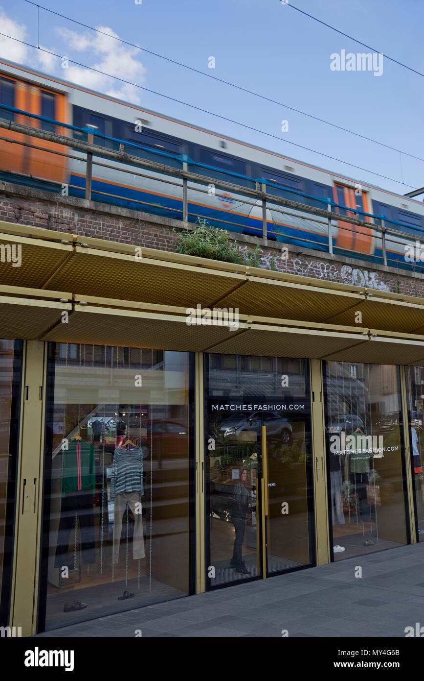 Small business under railway arches by train and overground station ...