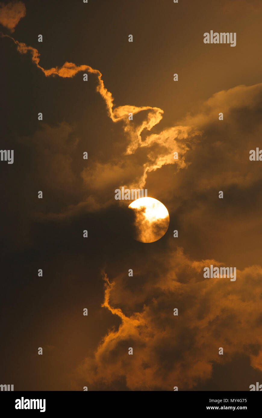 Sun breaking through dark clouds Stock Photo - Alamy