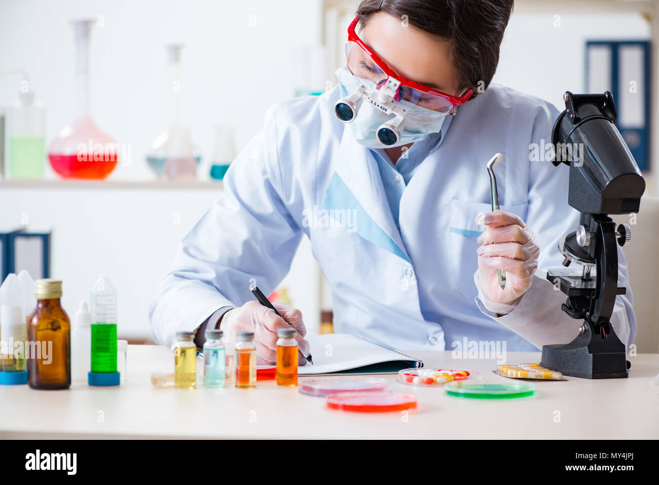 Lab assistant in drug synthesis concept Stock Photo - Alamy