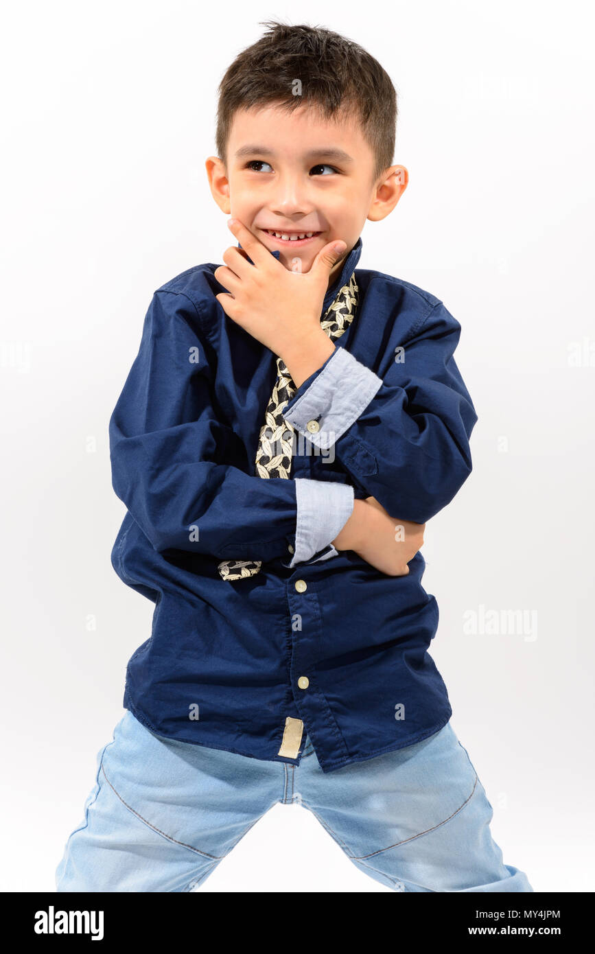 Studio shot of cute happy boy smiling and thinking Stock Photo - Alamy