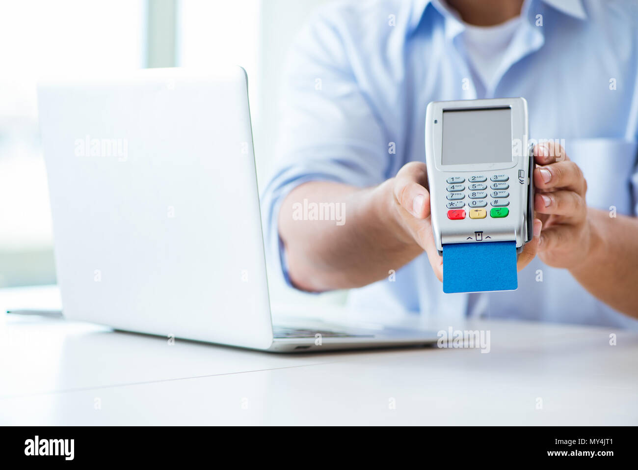 Man processing credit card transaction with POS terminal Stock Photo ...