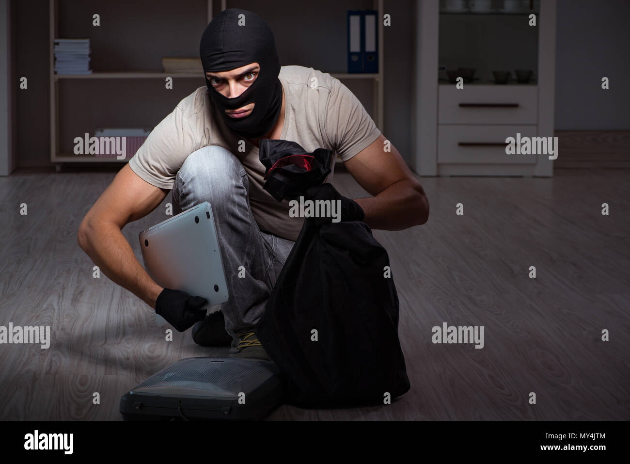 Burglar wearing balaclava mask at crime scene Stock Photo - Alamy