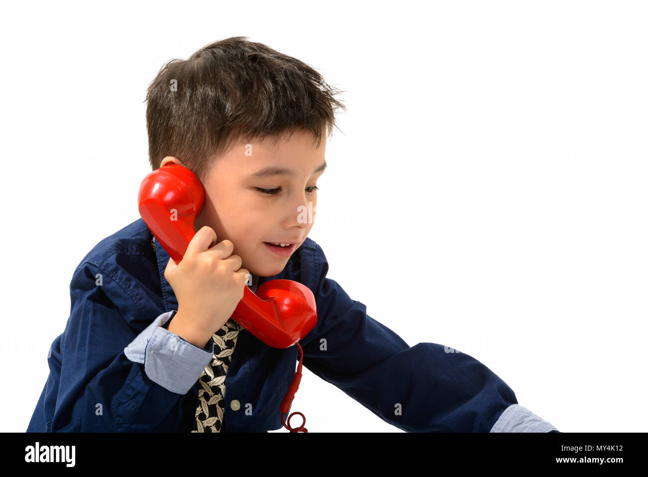 Studio shot of cute happy boy smiling and talking on old telepho Stock ...