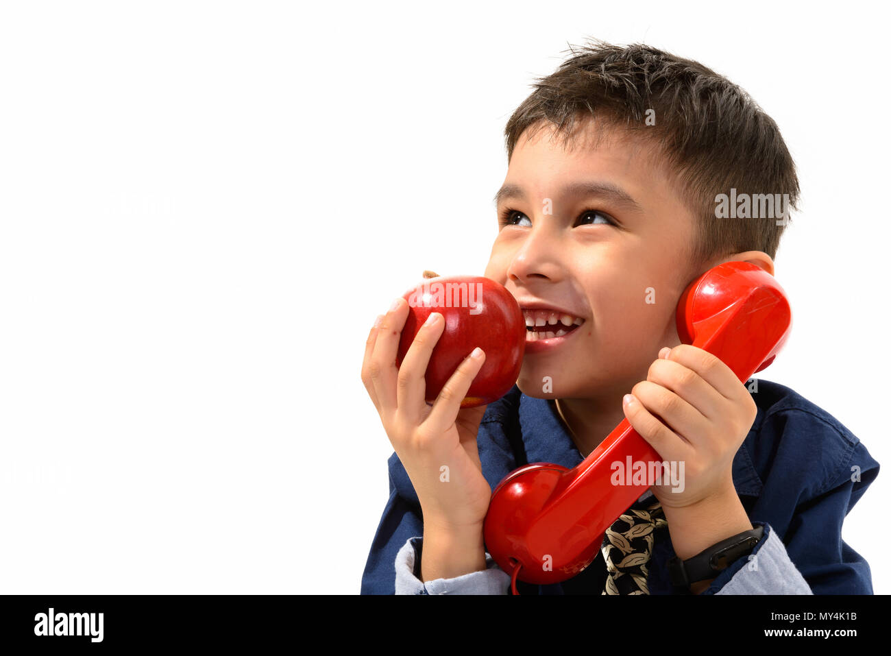 Thoughtful cute happy boy smiling while talking on old telephone Stock ...