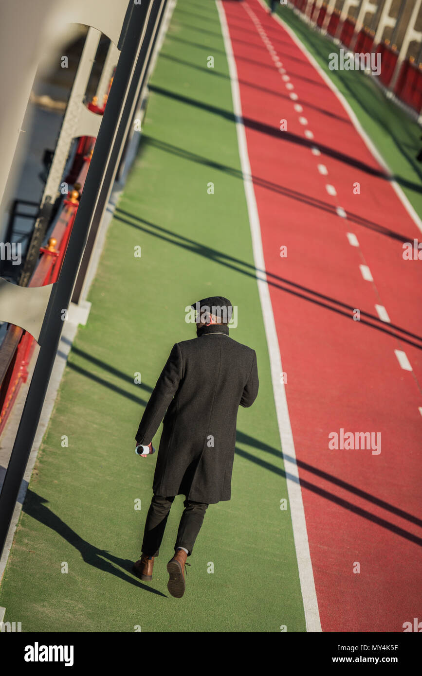 stylish middle aged man walking by pedestrian bridge Stock Photo - Alamy
