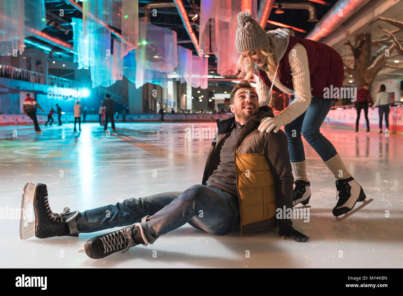 beautiful smiling young couple teaching ice skating on rink Stock Photo ...