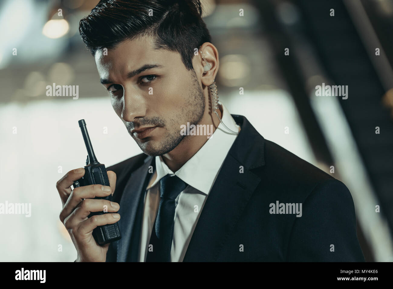 handsome security guard with portable radio looking at camera Stock ...