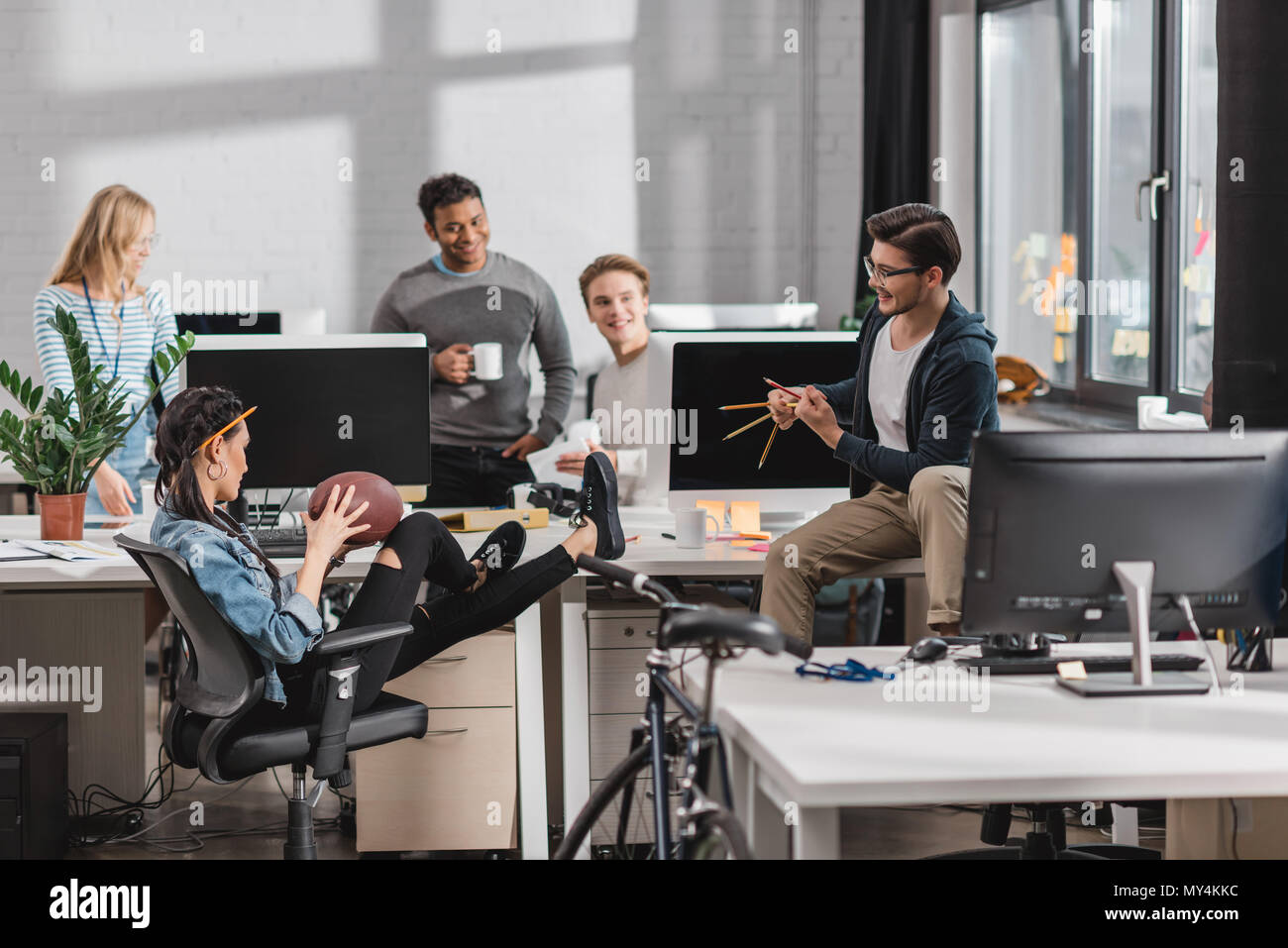 happy colleagues having fun at modern office Stock Photo - Alamy