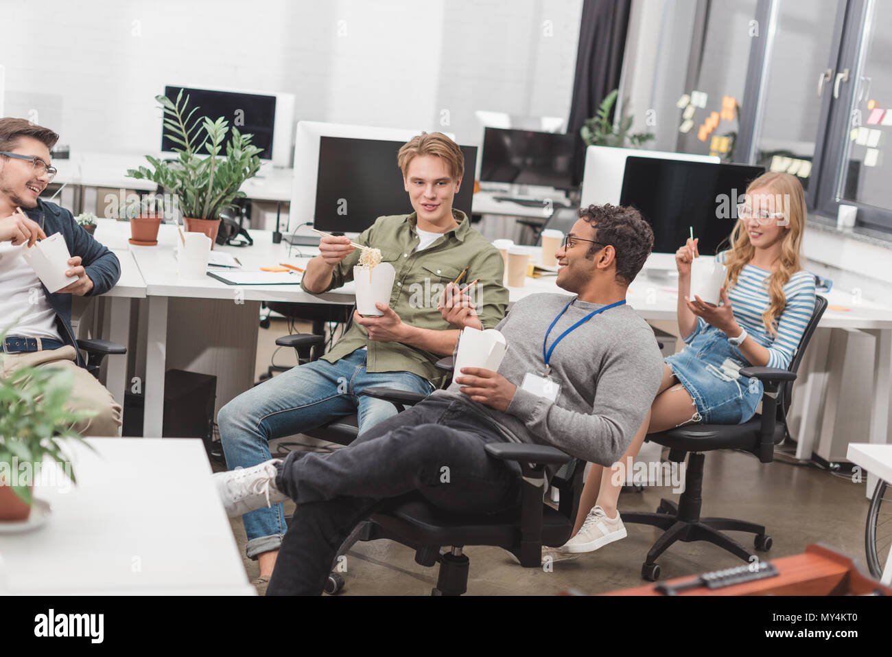 young happy colleagues eating thai food at modern office Stock Photo ...