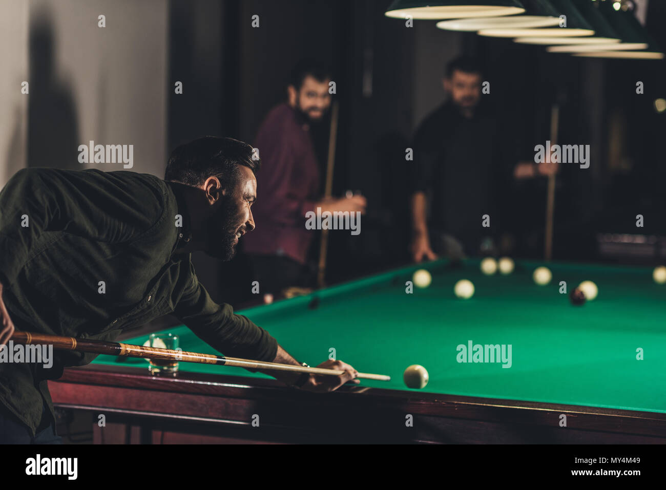 company of successful handsome men playing in pool at bar Stock Photo ...