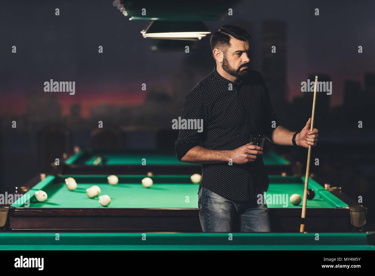 Young man standing at pool table hi-res stock photography and images ...