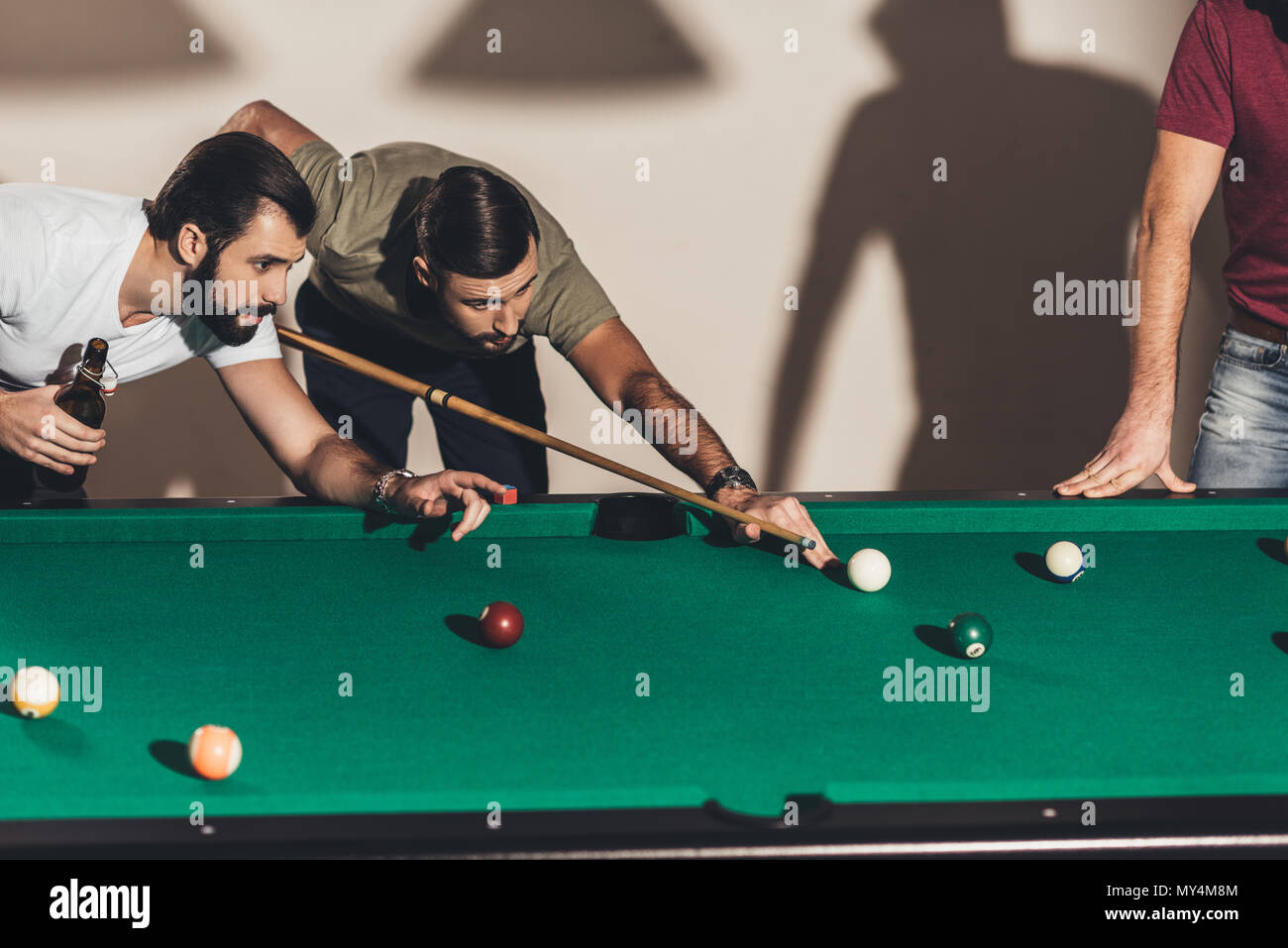 company of handsome men playing in pool Stock Photo - Alamy