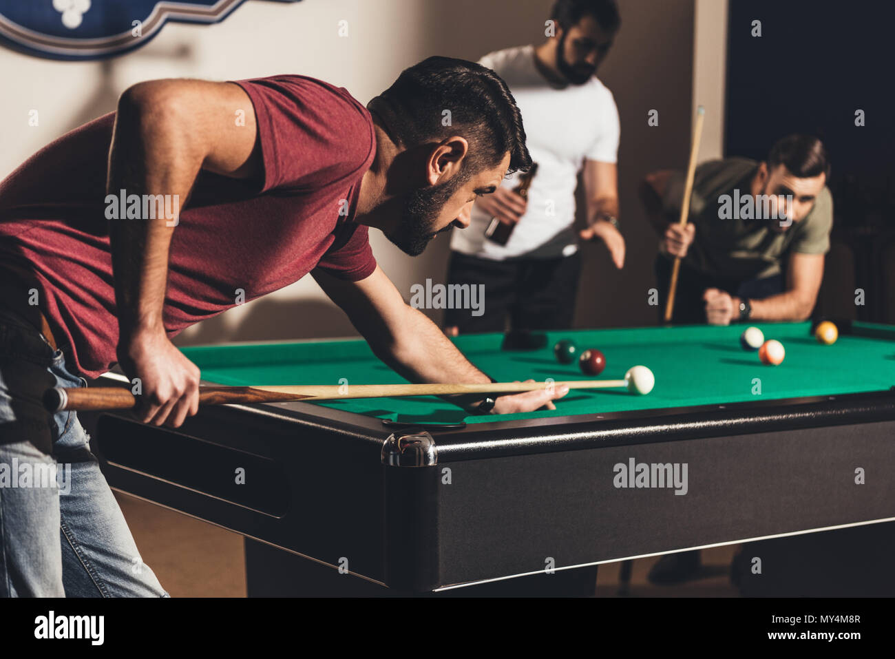 company of handsome men playing in pool Stock Photo - Alamy