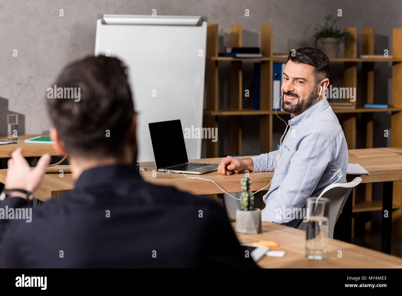 businessmen talking and laughing at work in office Stock Photo - Alamy