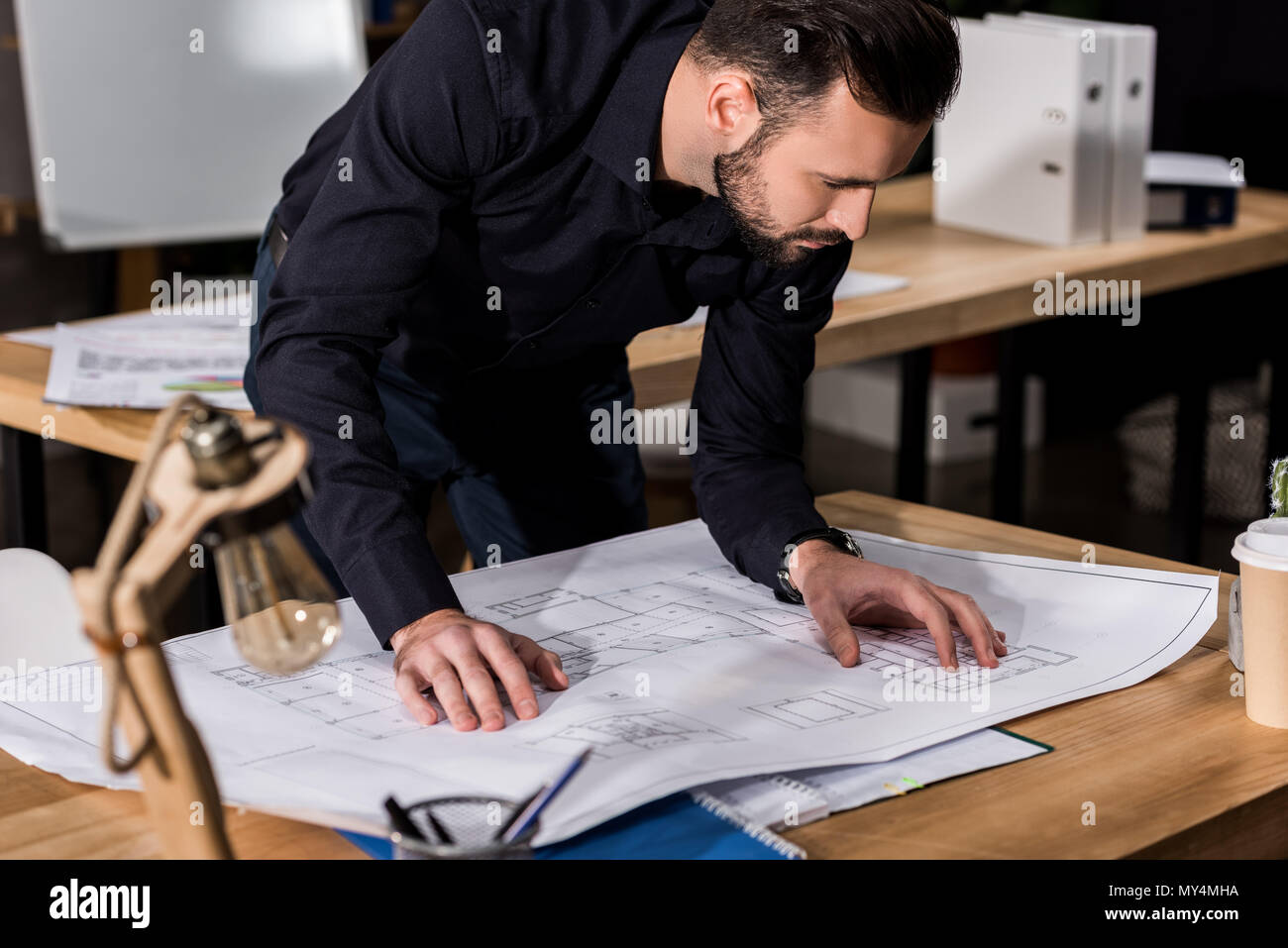 handsome architect looking at blueprints on table Stock Photo - Alamy