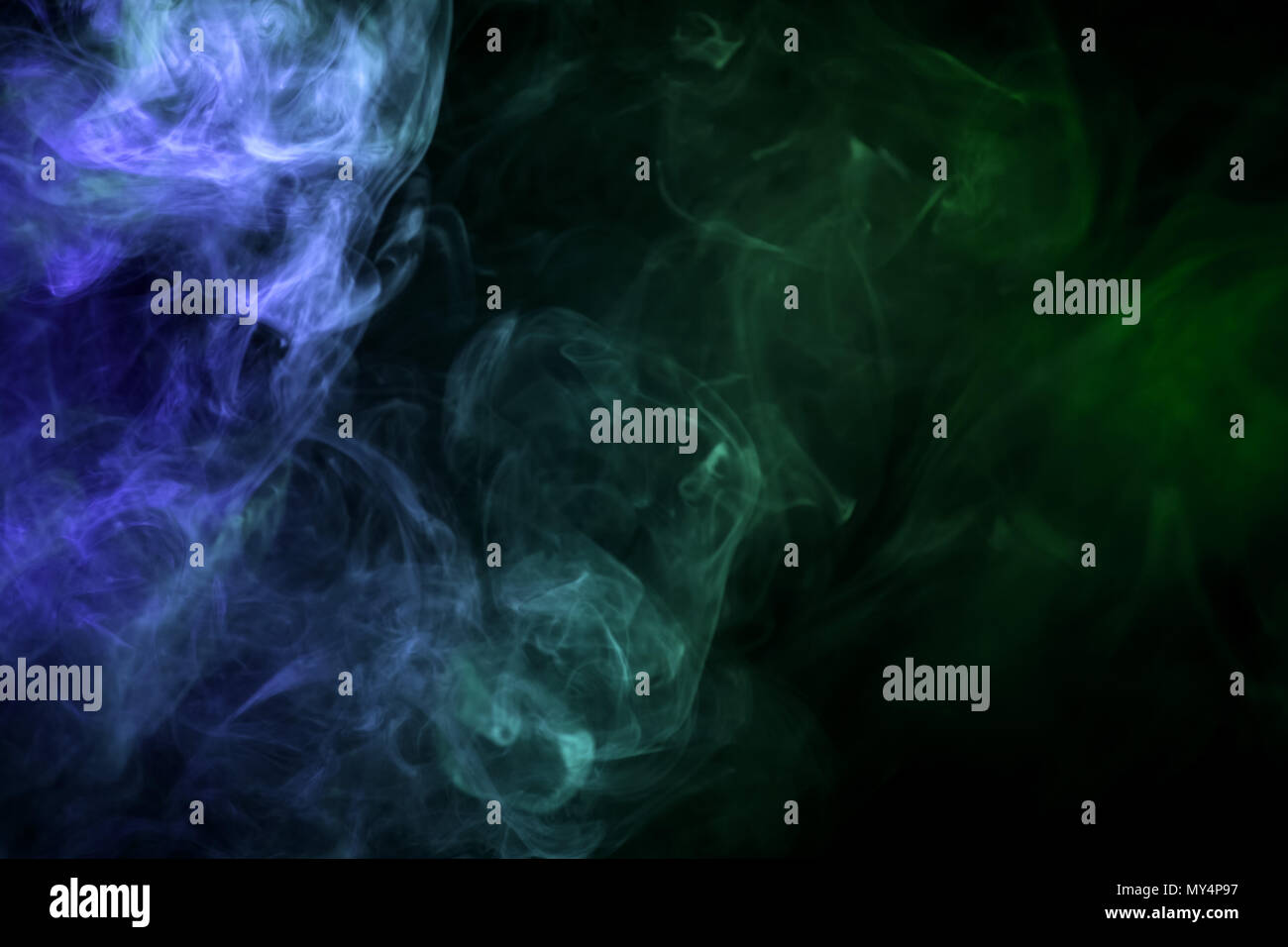 Thick green, blue smoke on a black isolated background. Background from ...