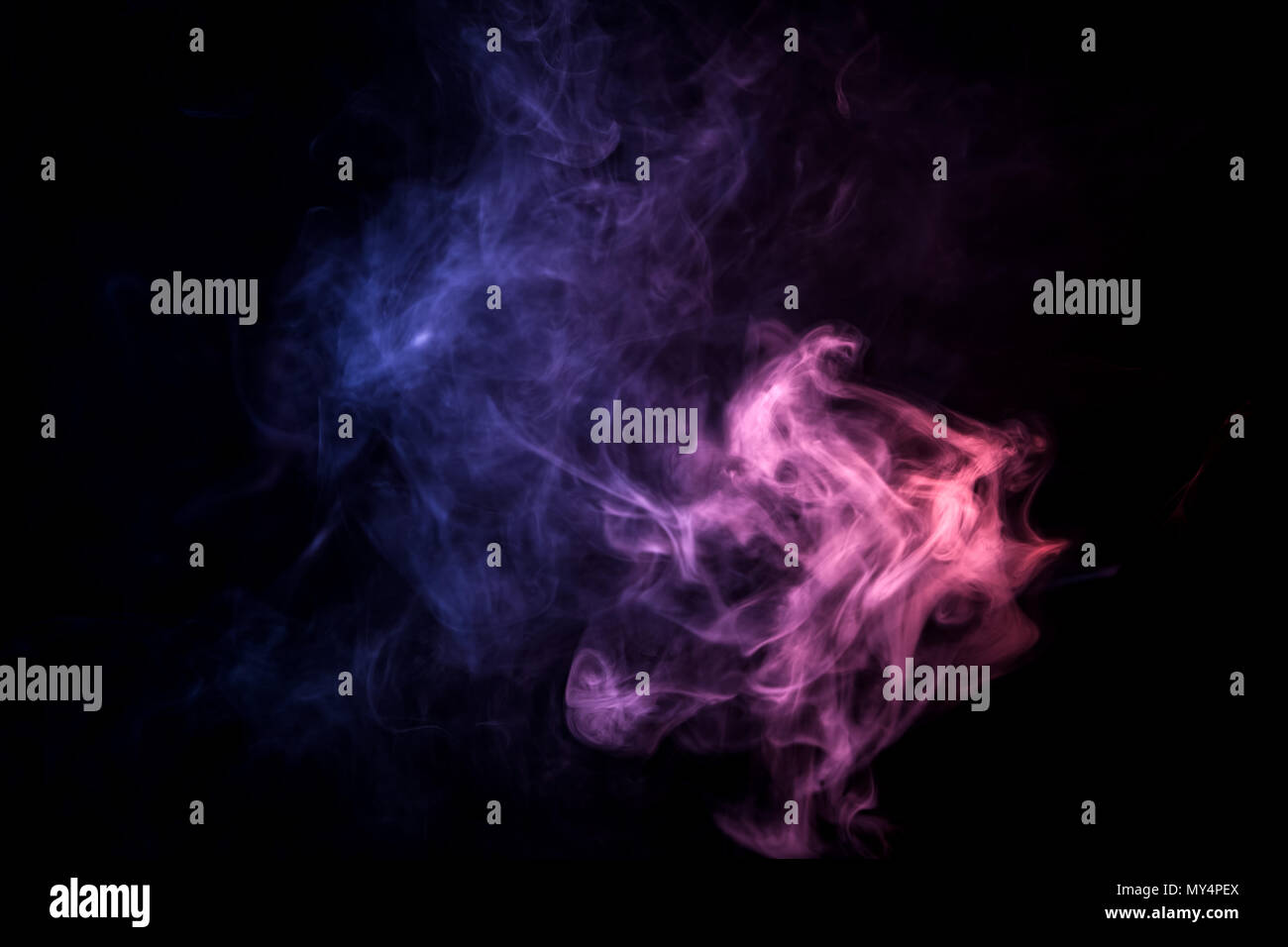 Cloud of blue,pink,purple smoke on a black isolated background ...