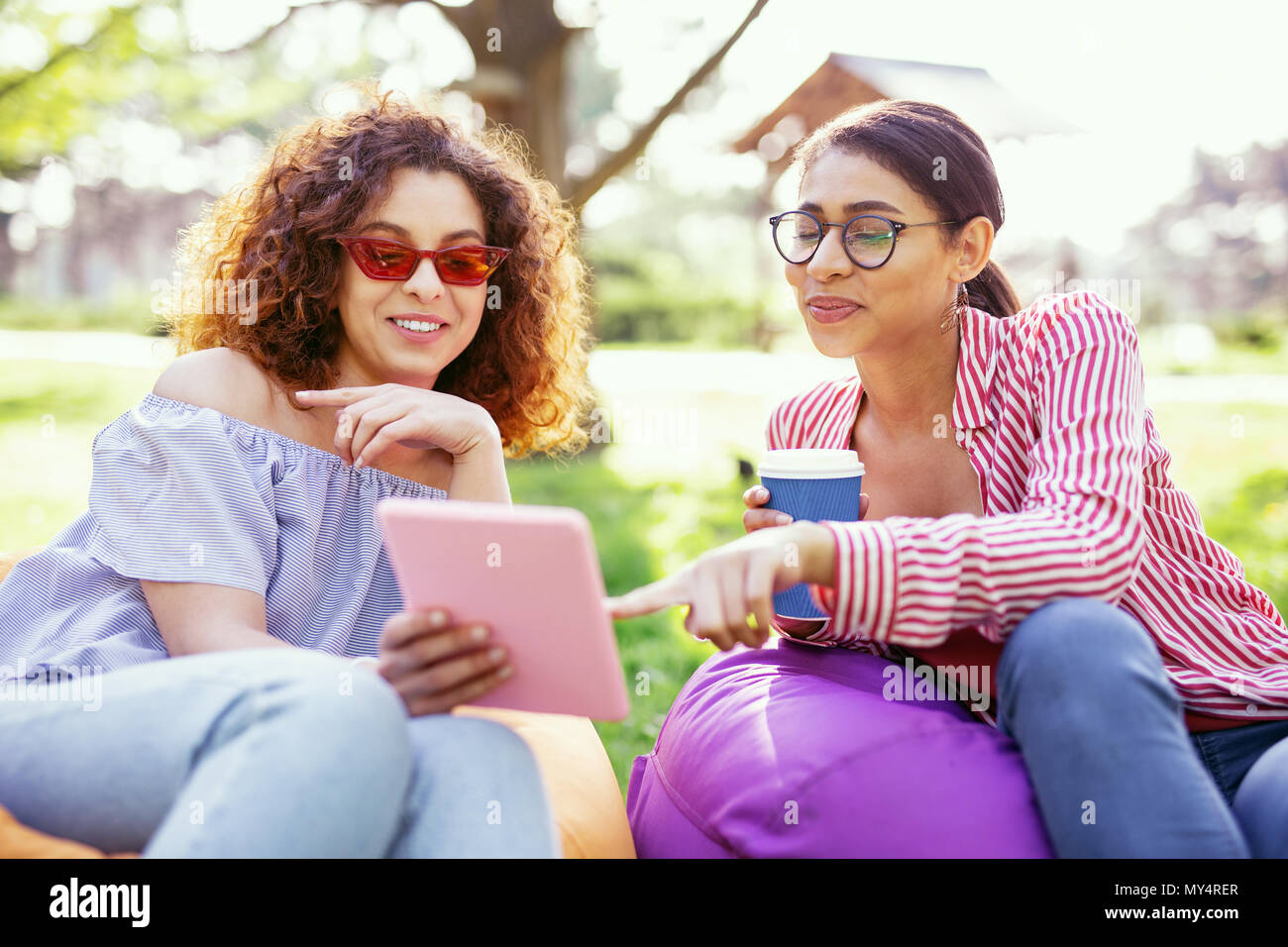 Happy friends looking through some photos Stock Photo - Alamy
