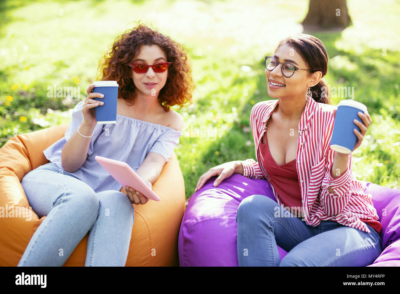 Cheerful young women talking and relaxing Stock Photo - Alamy