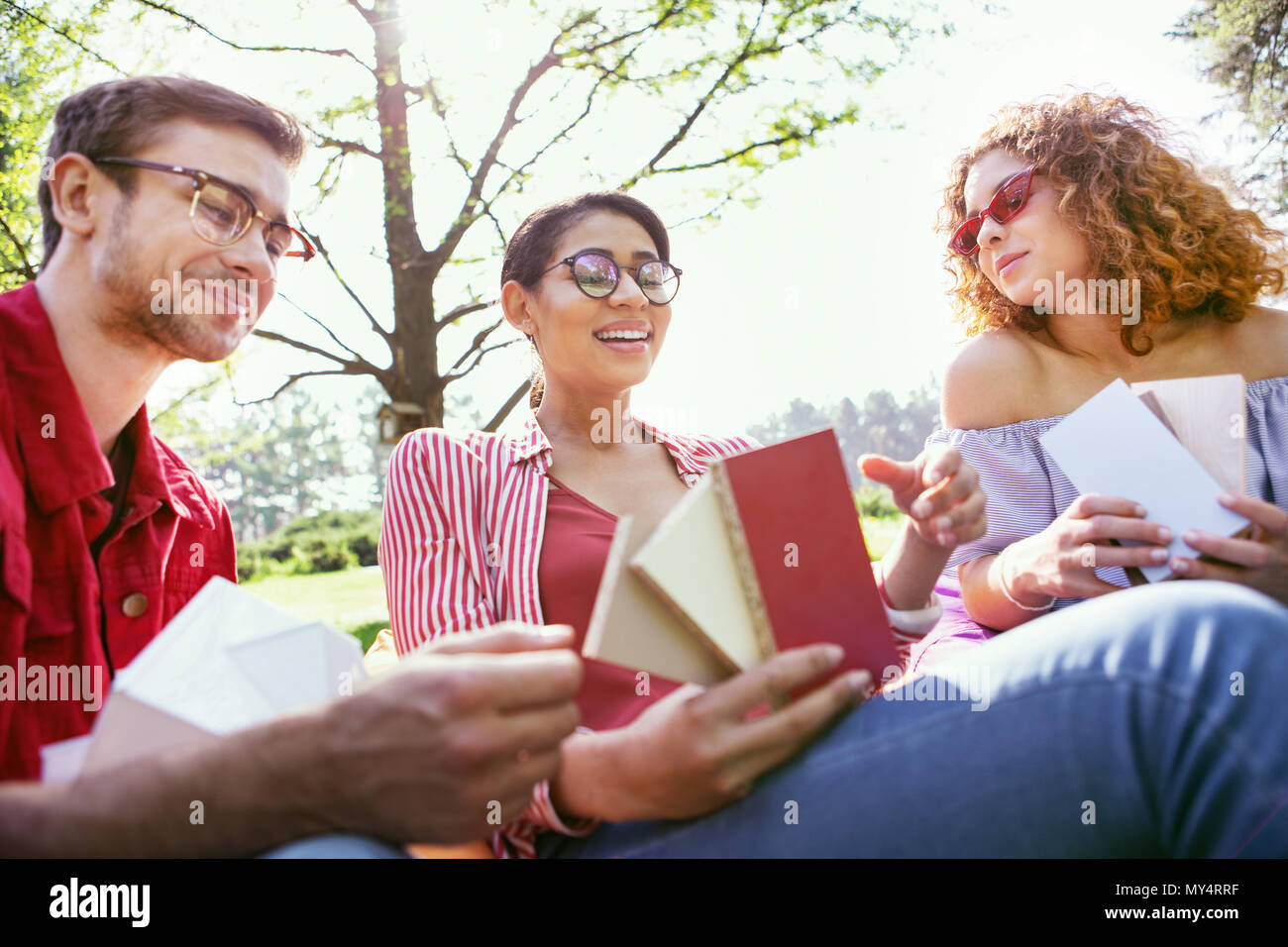Alert woman choosing material with her colleagues Stock Photo - Alamy