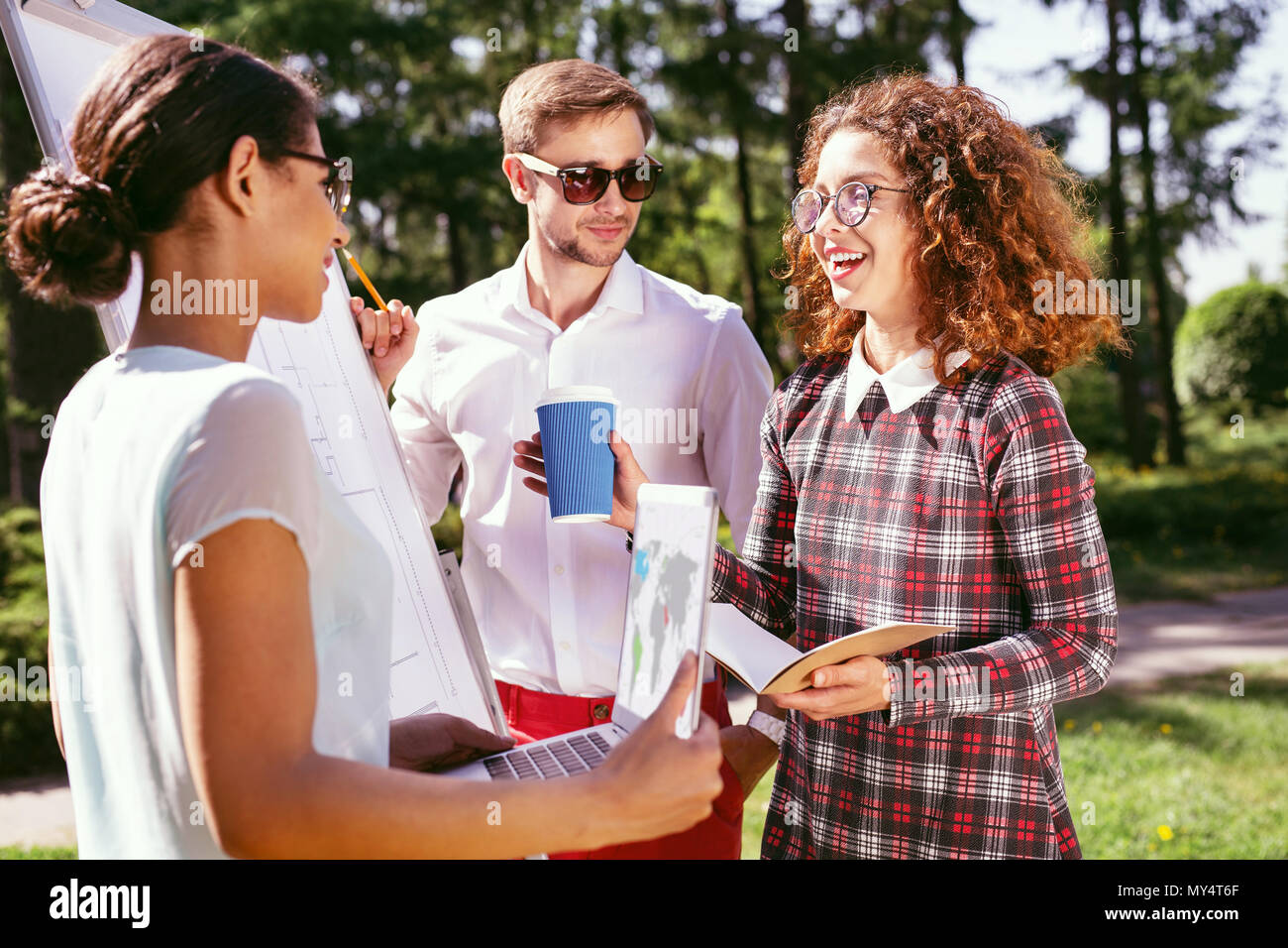 Cheerful students doing their homework project Stock Photo - Alamy