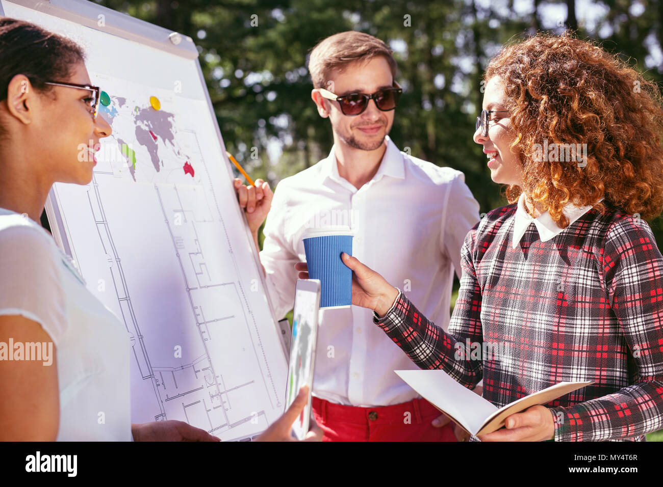 Inspired students doing their homework project Stock Photo - Alamy