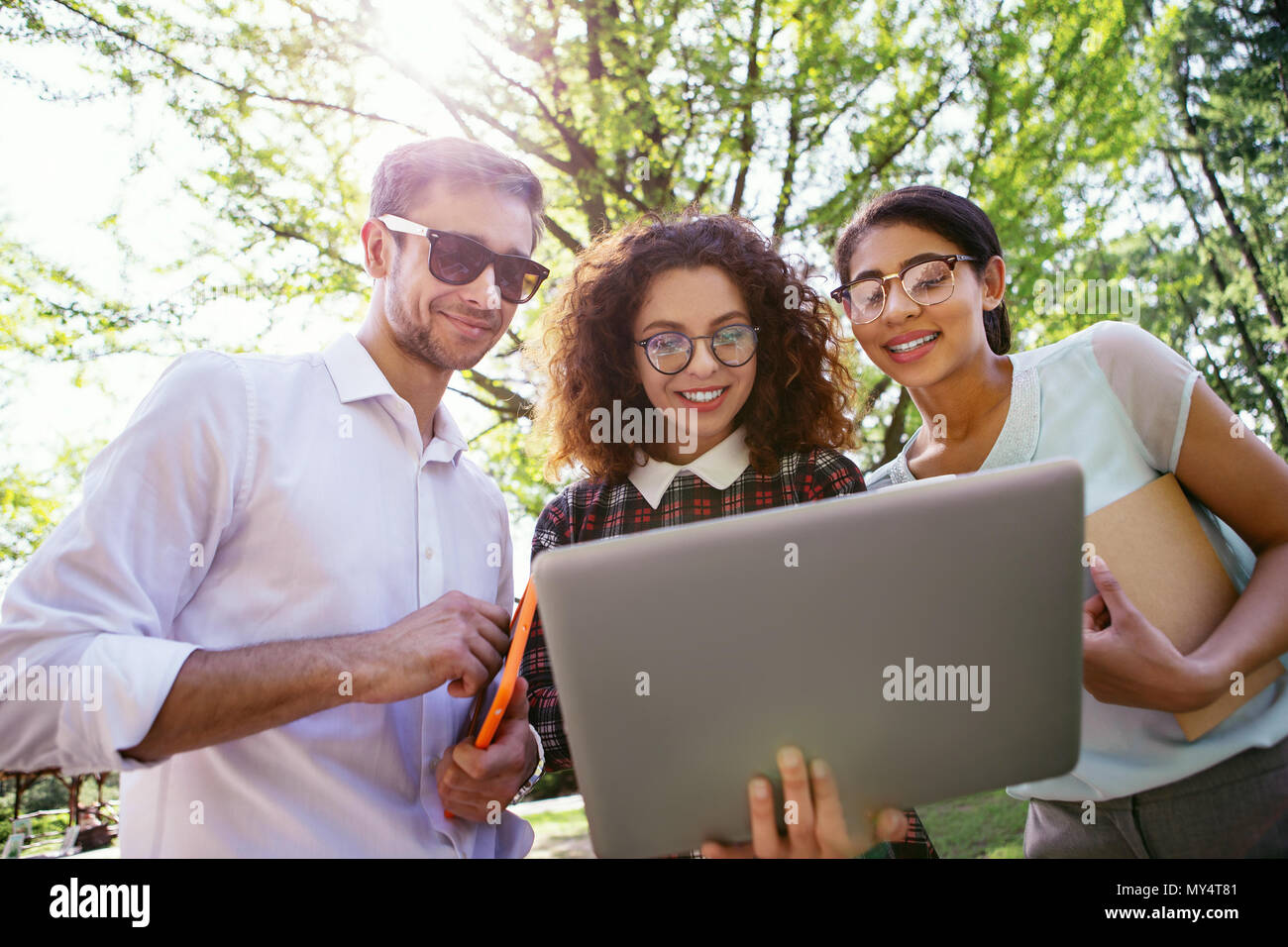 Happy students doing their homework together Stock Photo - Alamy