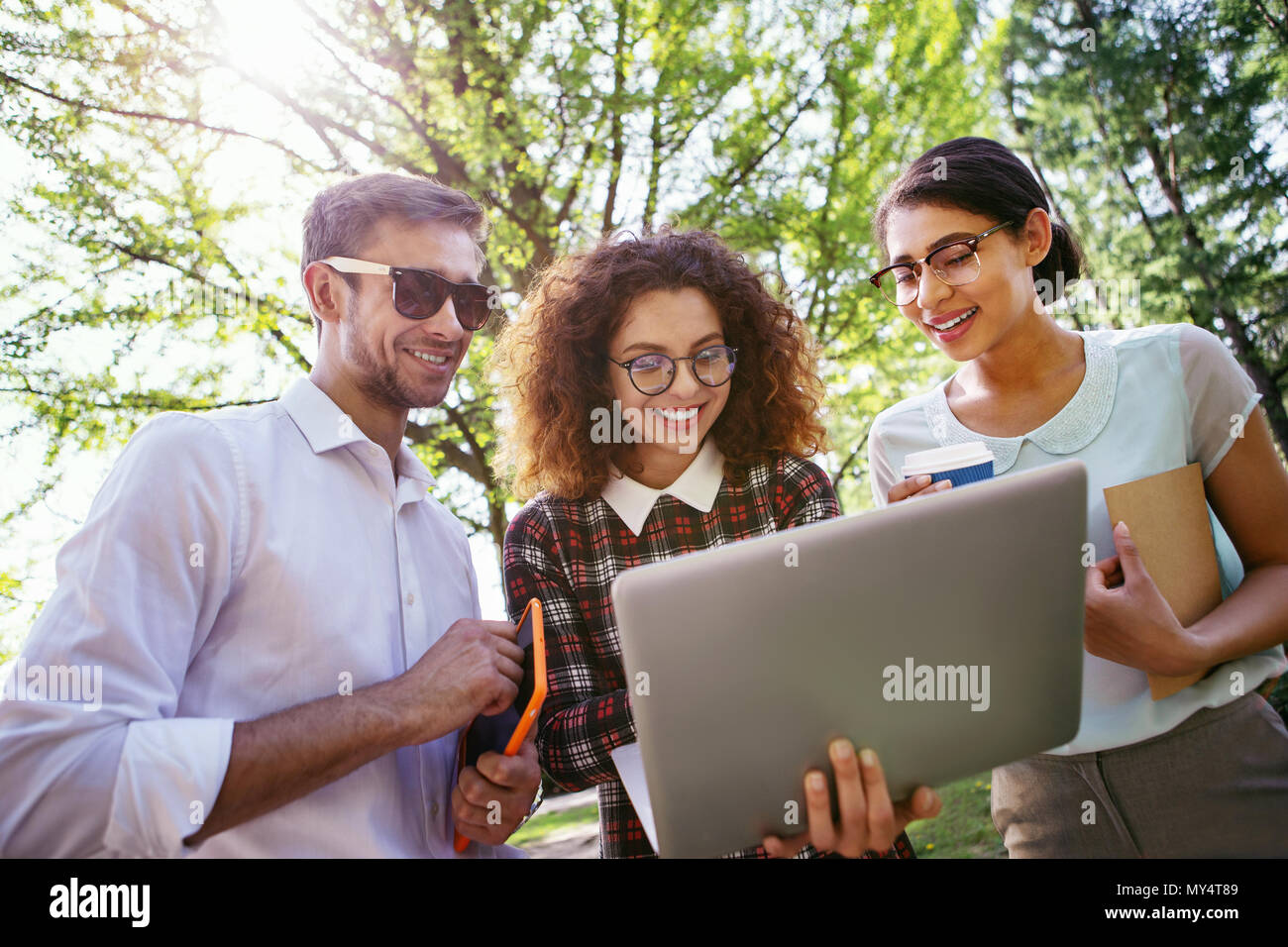 Inspired students doing their homework together Stock Photo - Alamy