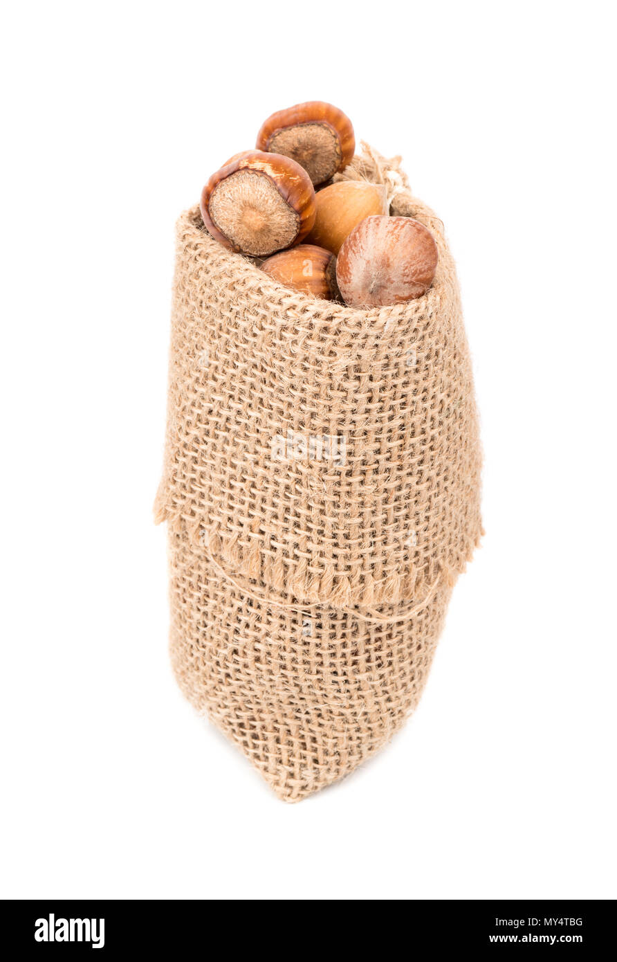 Hazelnuts in shell and bag isolated on white background Stock Photo - Alamy