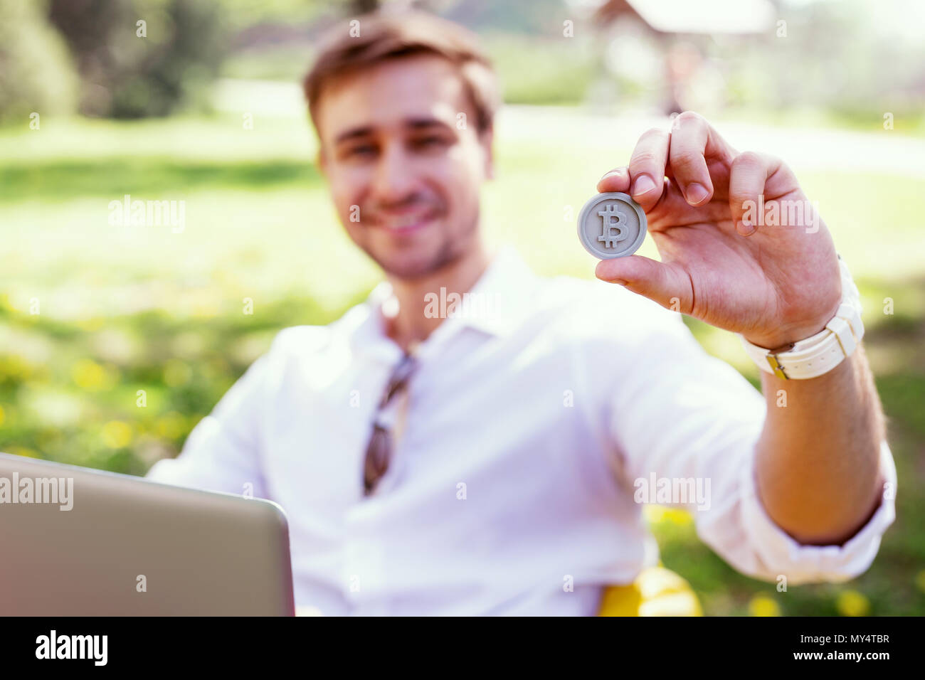 Alert young man holding a coin Stock Photo - Alamy