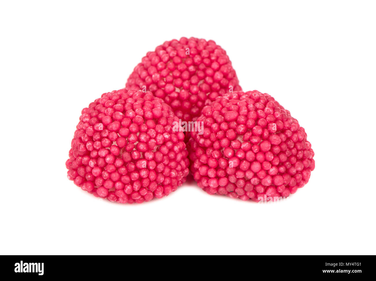 Three red berry jelly candies on a white background Stock Photo - Alamy