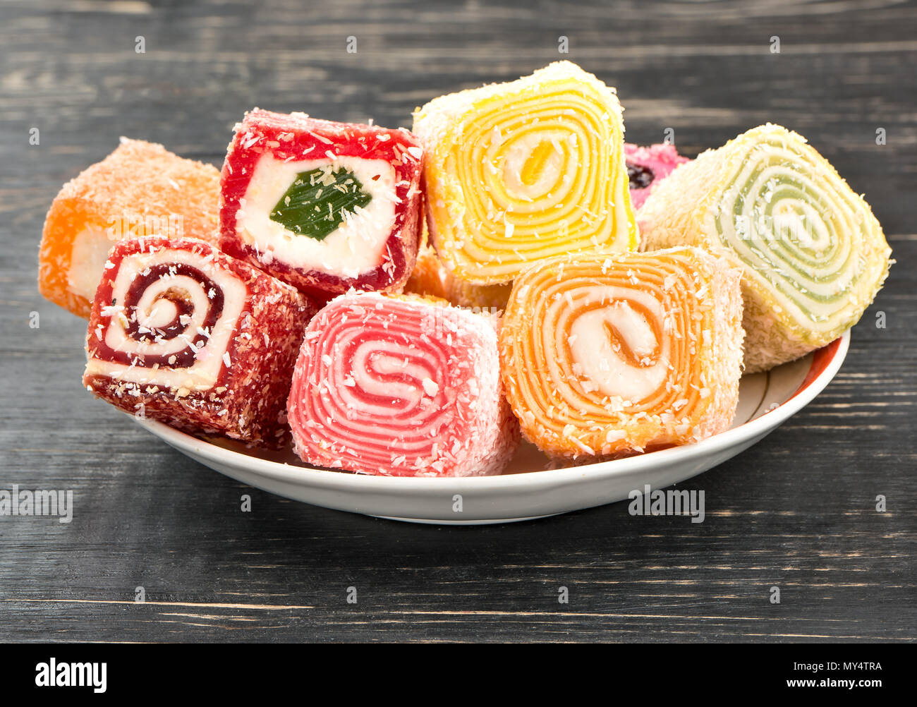 Plate with various pieces of turkish delight lokum on a wooden ...