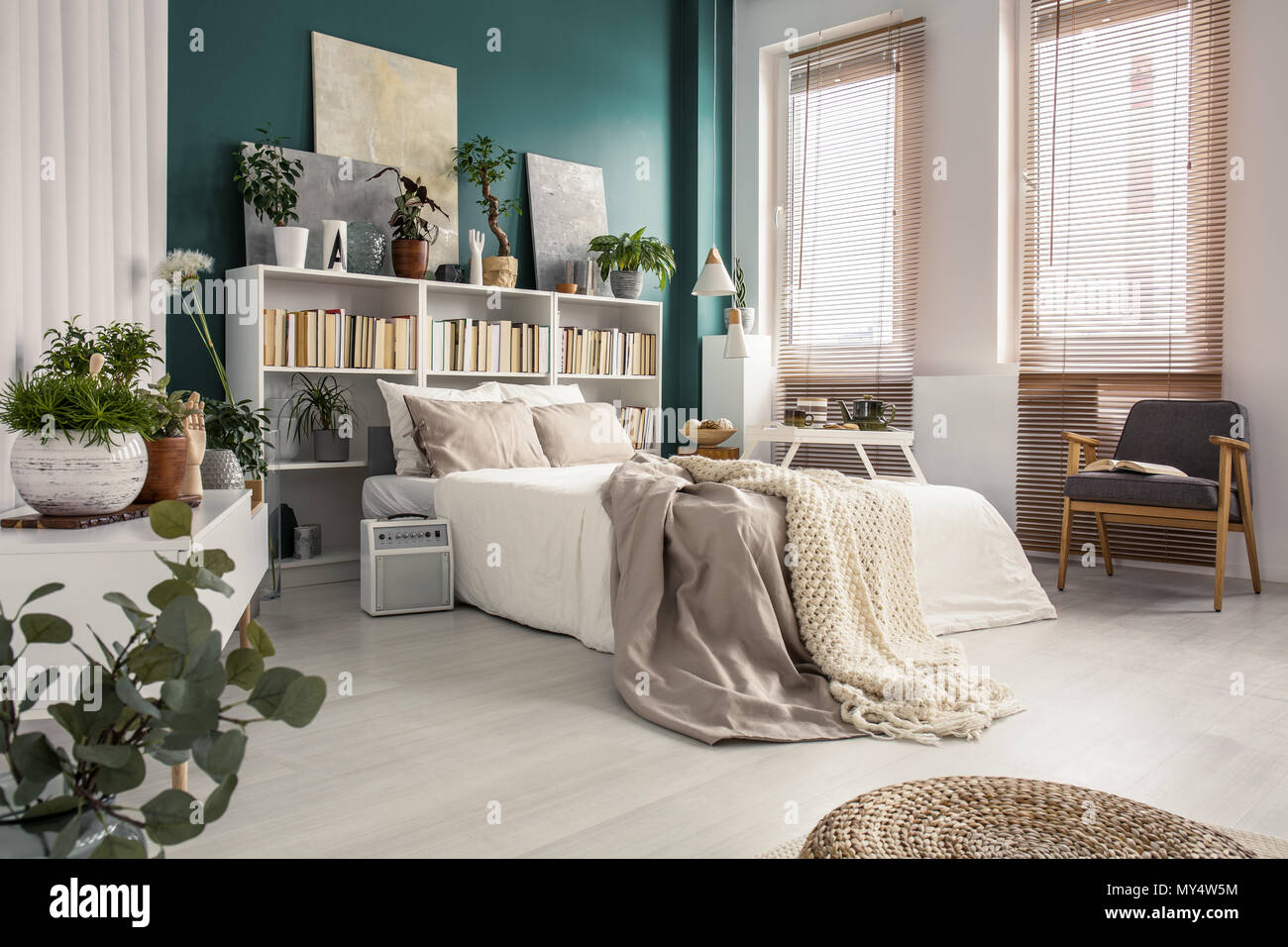 Side view of king size bed with pillows and blankets in bedroom ...