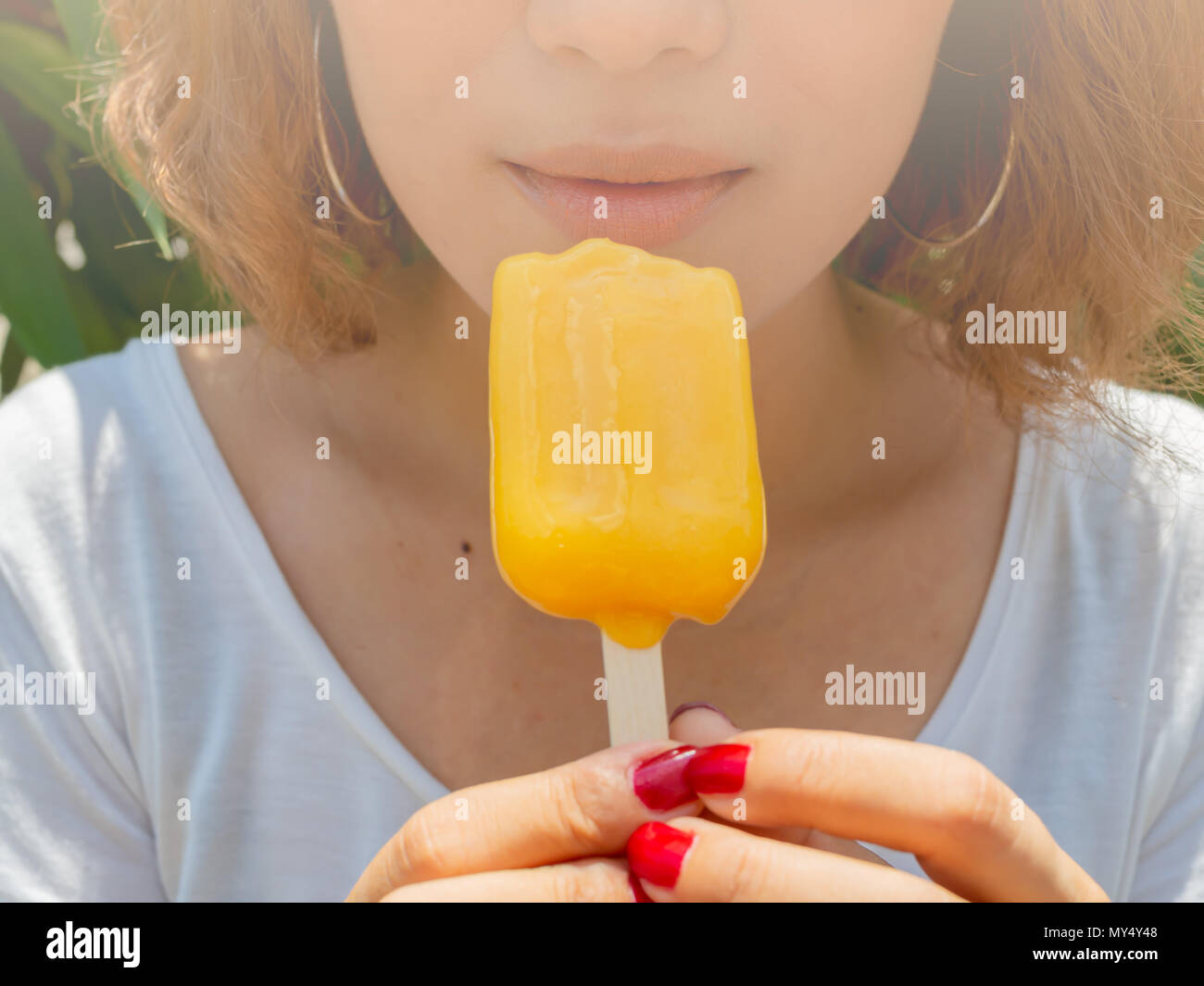Girl eating popsicle ice cream hi-res stock photography and images - Alamy