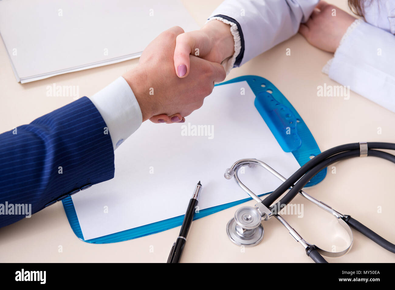 Man signing medical insurance contract Stock Photo - Alamy