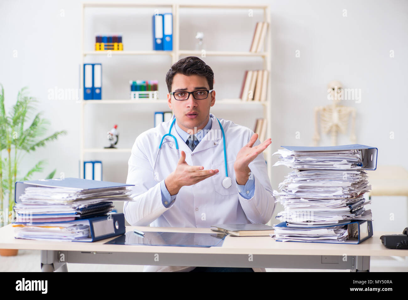 Busy doctor with too much work in hospital Stock Photo - Alamy
