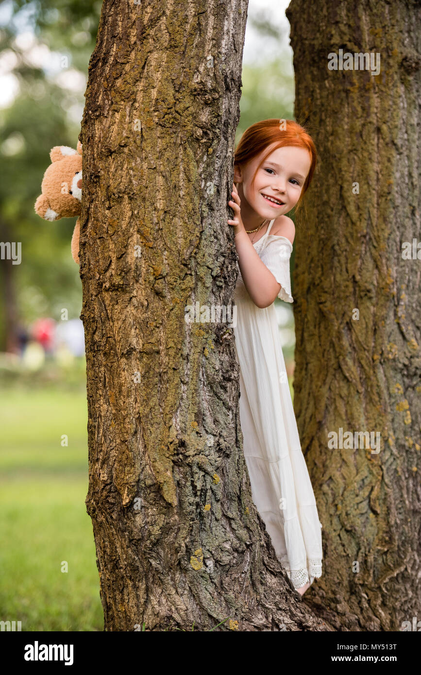 Cute kid hiding teddy bear hi-res stock photography and images - Alamy