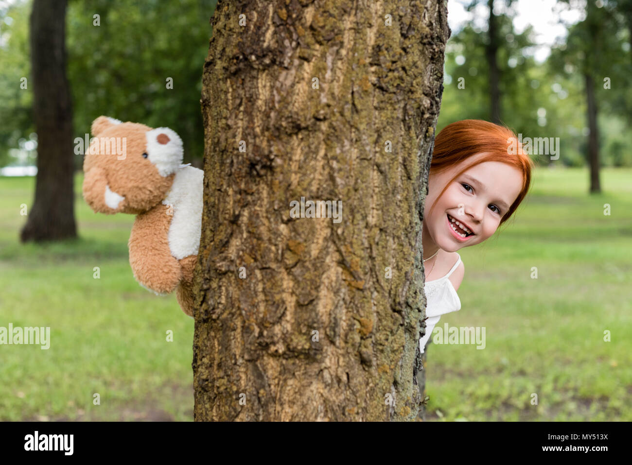 Cute kid hiding teddy bear hi-res stock photography and images - Alamy