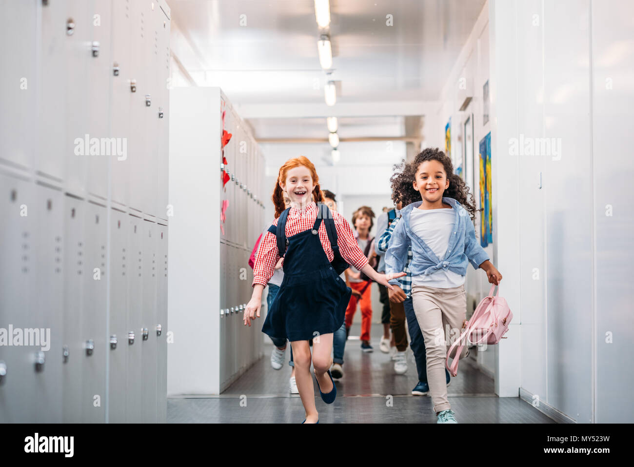 cute funny pupils running through school corridor Stock Photo - Alamy