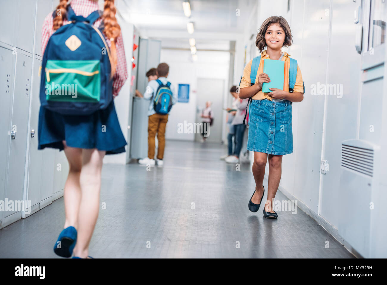 beautiful little kids walking through school corridor Stock Photo - Alamy