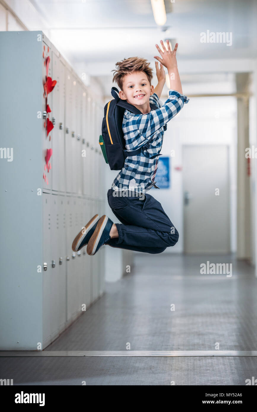 adorable little boy jumping in school corridor Stock Photo - Alamy