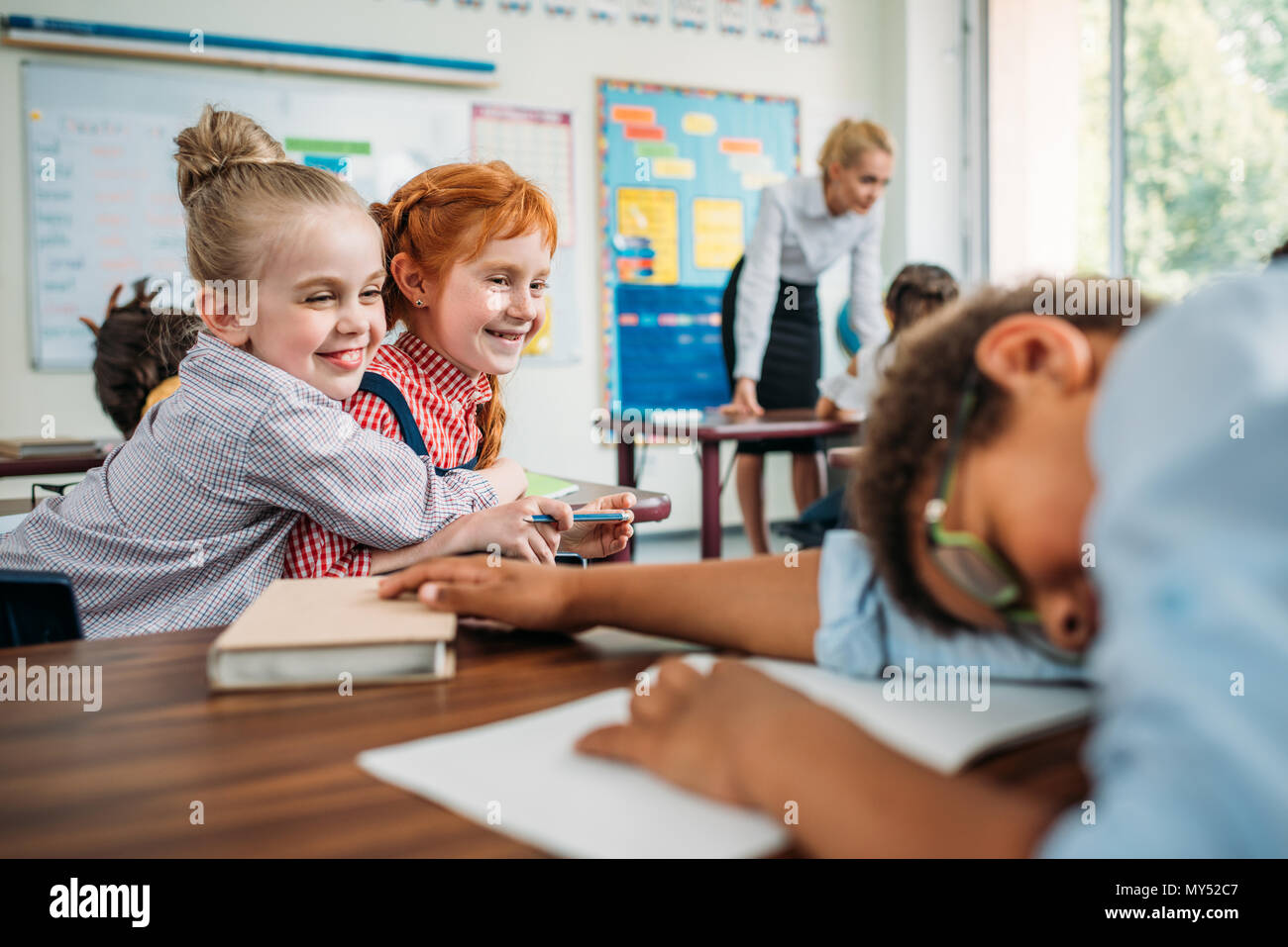 beautiful schoolgirls laughing of sleeping classmate in class Stock ...