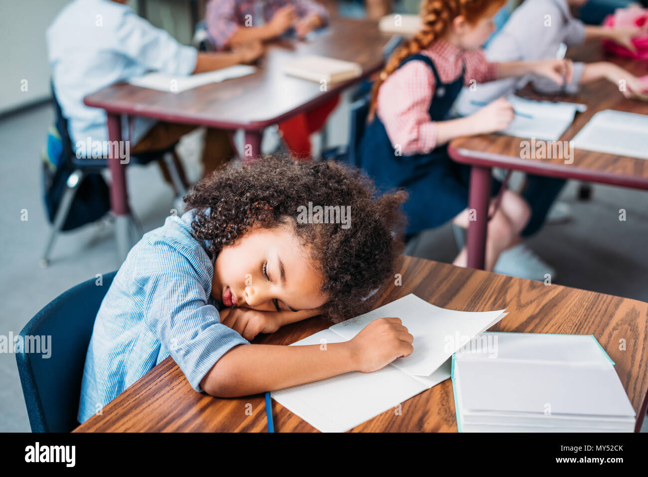 exhausted african american schoolgirl sleeping in class Stock Photo - Alamy