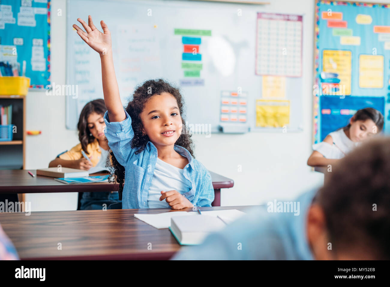 african american girl raising hand in class Stock Photo - Alamy