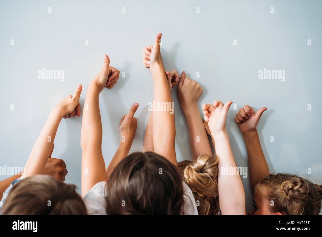 back view of group of kids showing thumbs up Stock Photo - Alamy