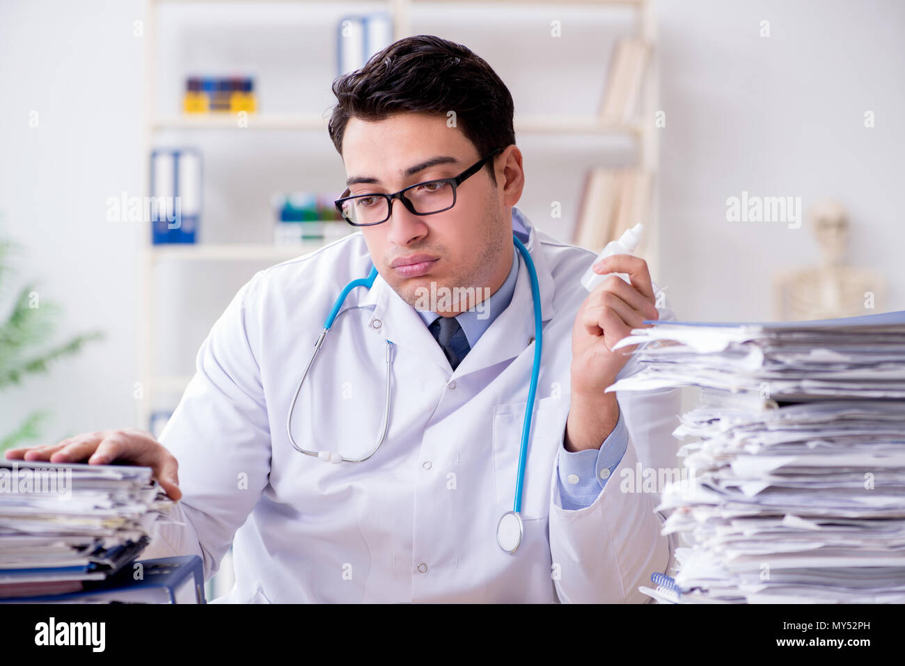 Busy doctor with too much work in hospital Stock Photo - Alamy