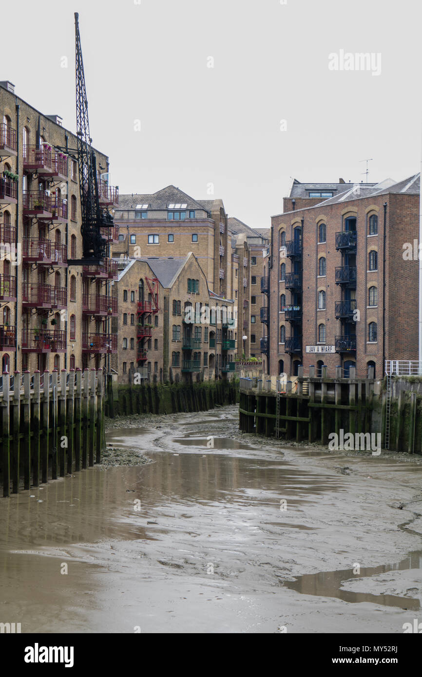 The tides out along a thames creek in old London town with old ...