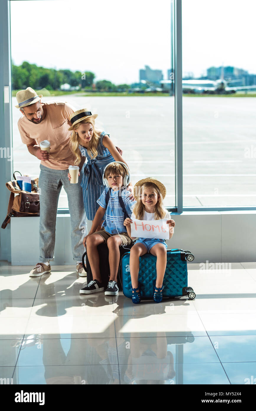 parents and kids waiting for boarding together in airport Stock Photo ...