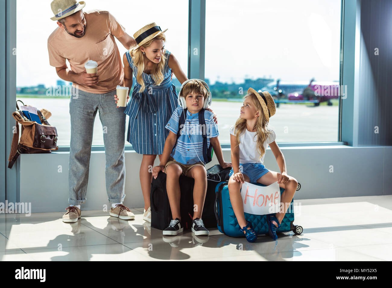 parents and kids waiting for boarding together in airport Stock Photo ...